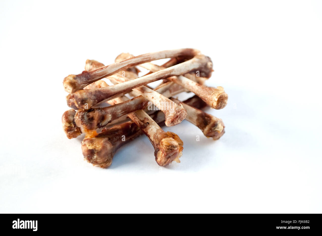 Pile of chicken bones on white background Stock Photo - Alamy