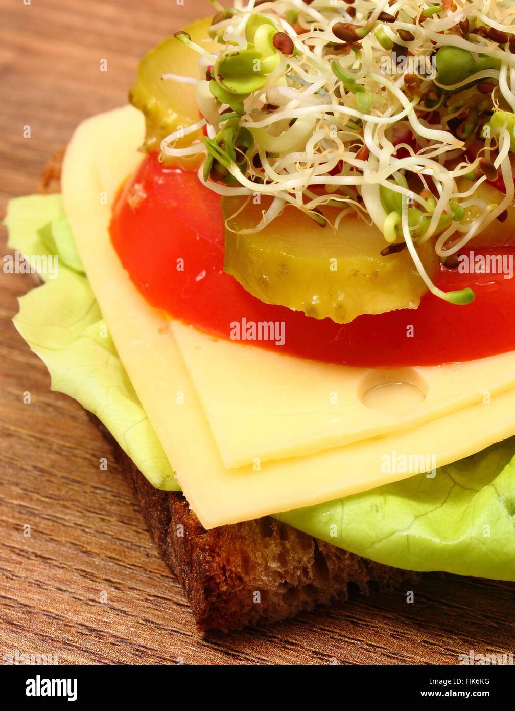 Freshly prepared vegetarian sandwich with alfalfa and radish sprouts ...