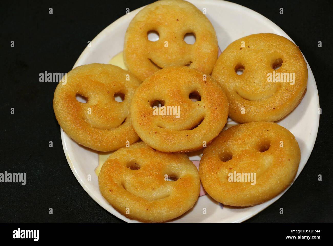 Snack made with potato - fried potato as smile shape ; a popular Indian ...