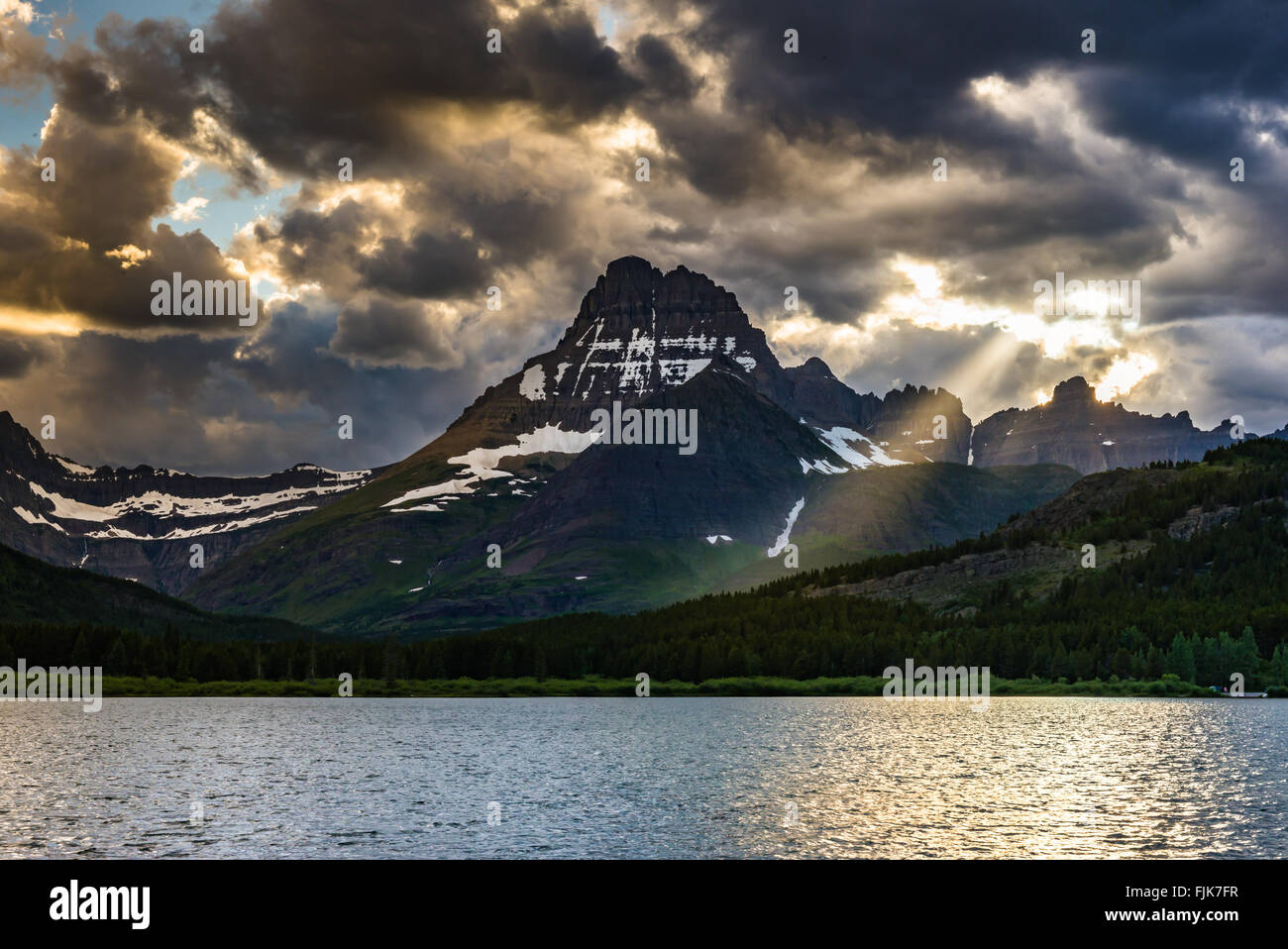 Colorful sunset over Swiftcurrent Lake in Glacier National Park ...