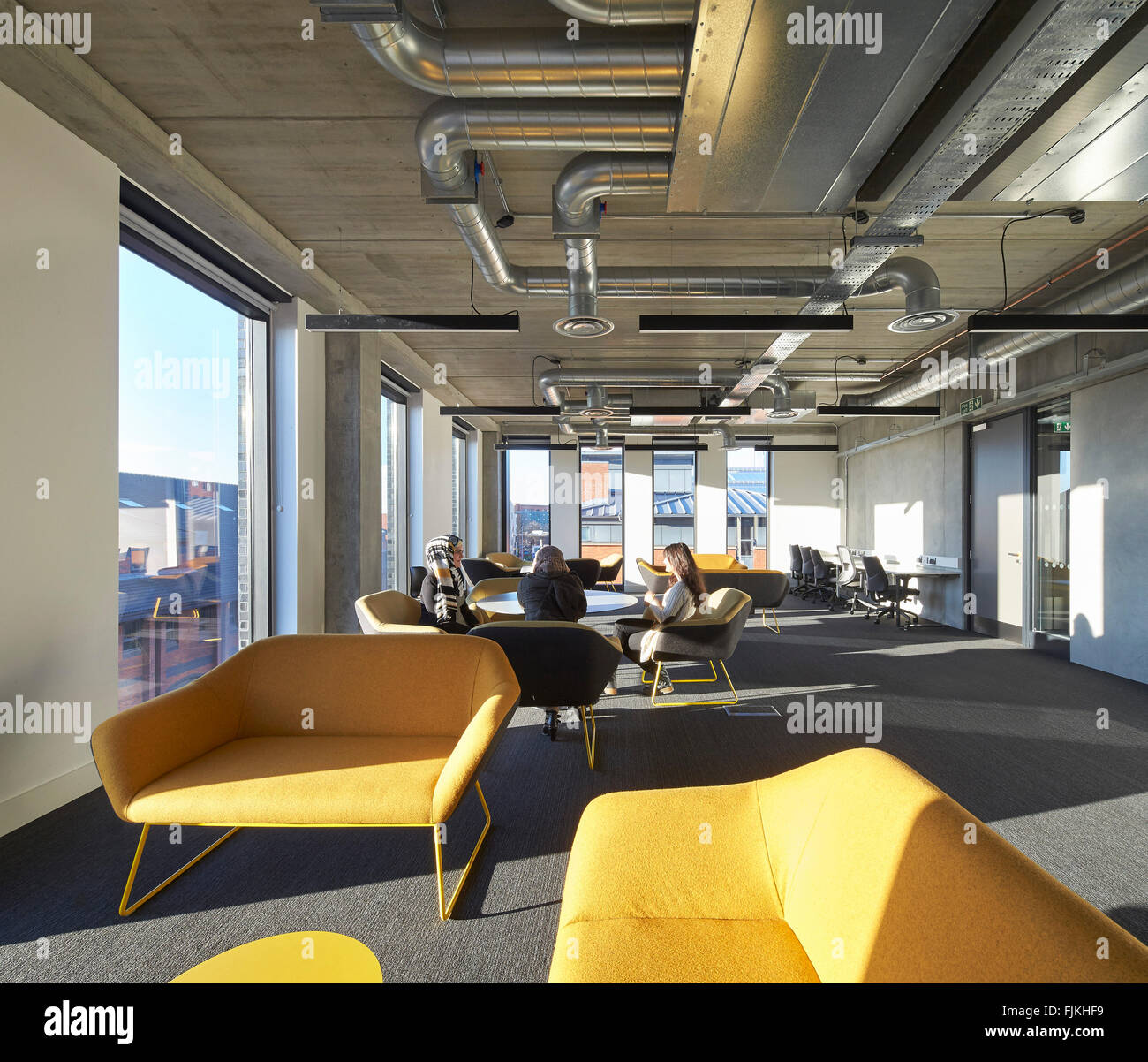 Break out area with exposed ceiling and fenetsration. MMU Student Union ...