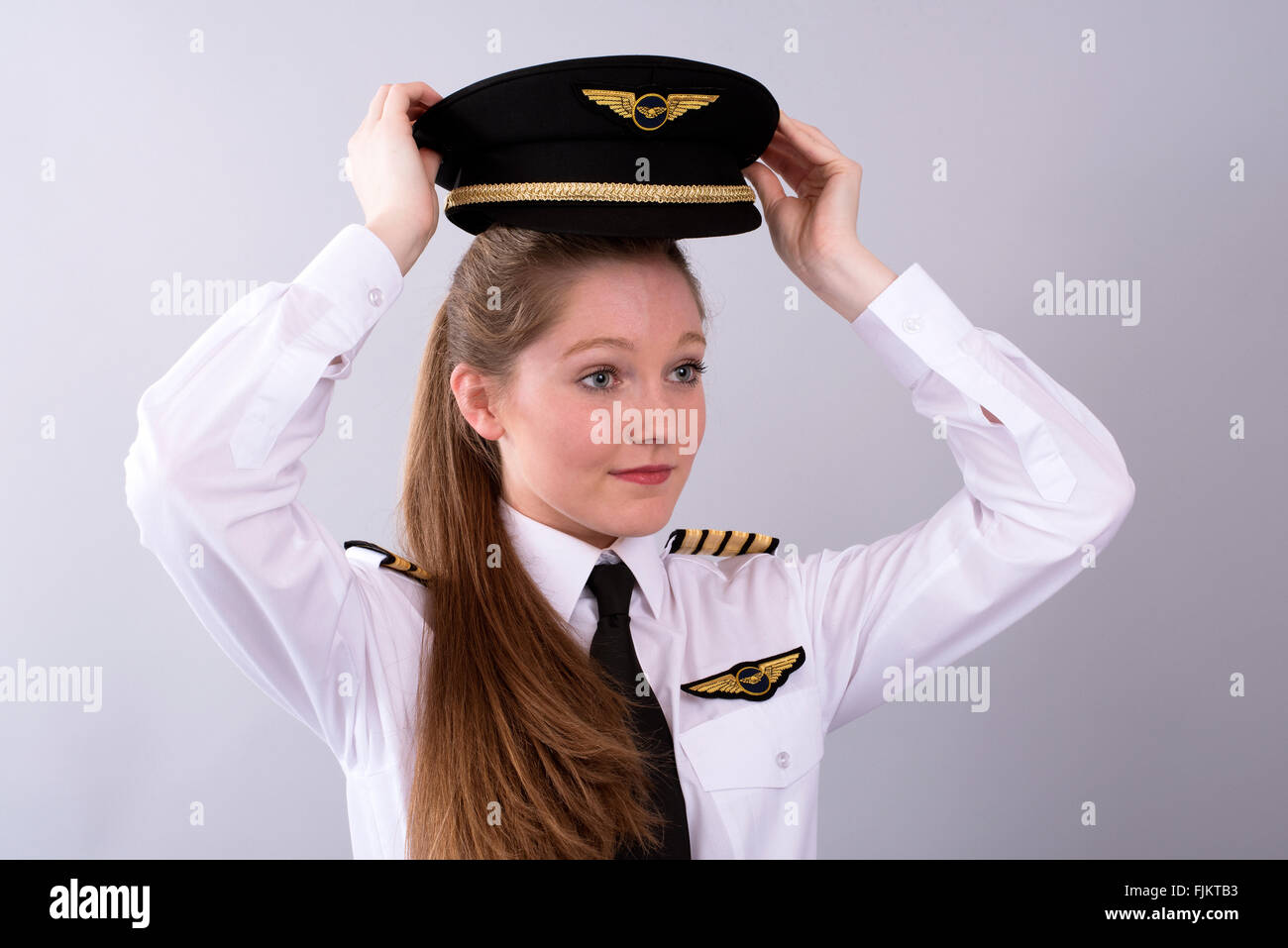 Attractive young female airline pilot hi-res stock photography and ...