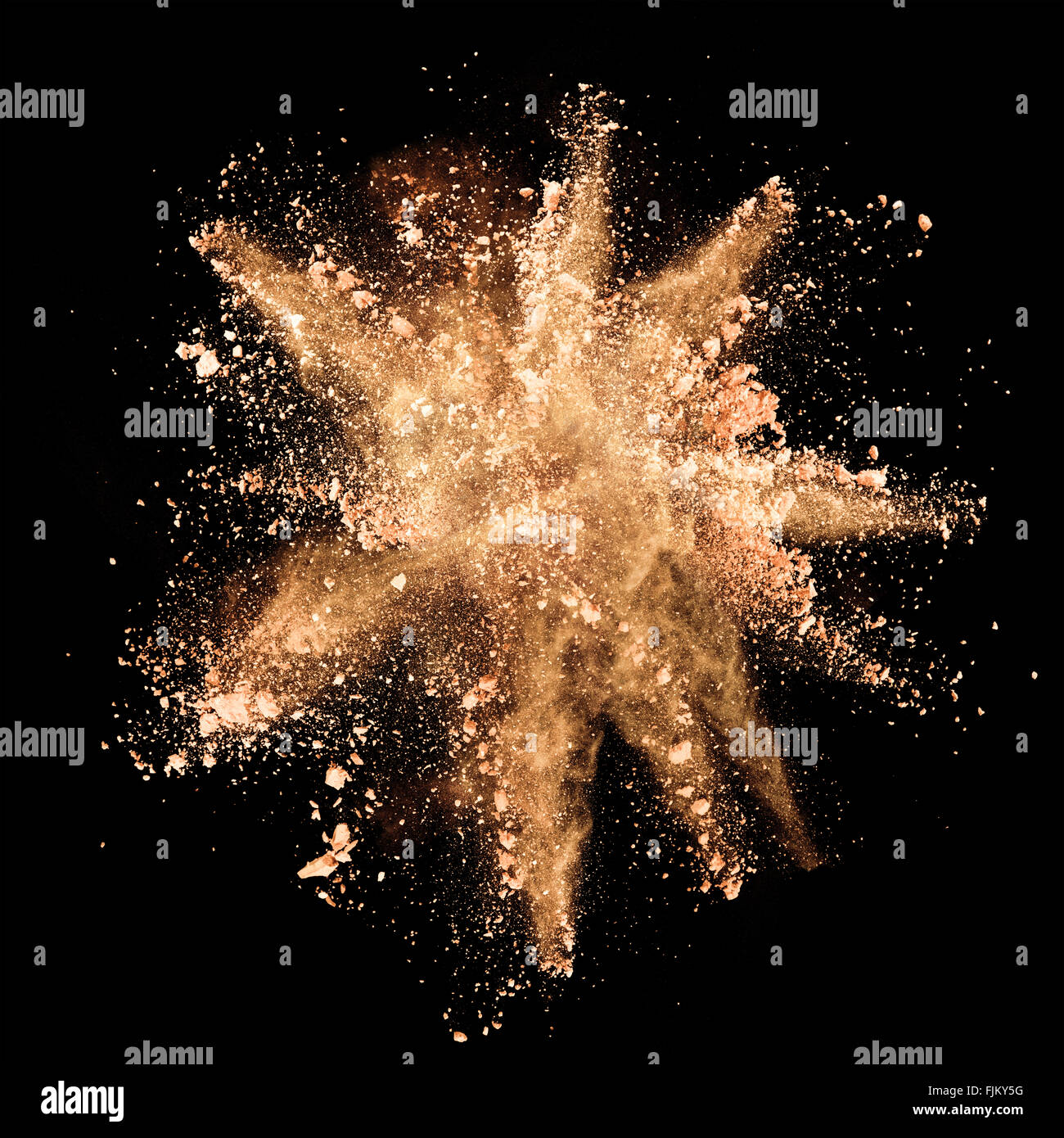 Explosion of brown powder on black background Stock Photo - Alamy