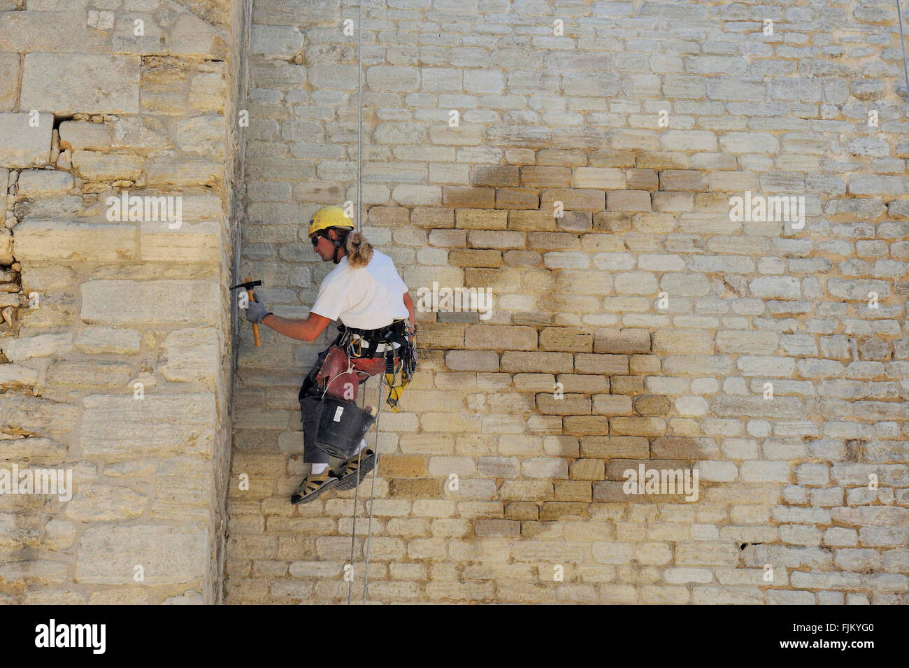Man climbing up brick wall hi-res stock photography and images - Alamy