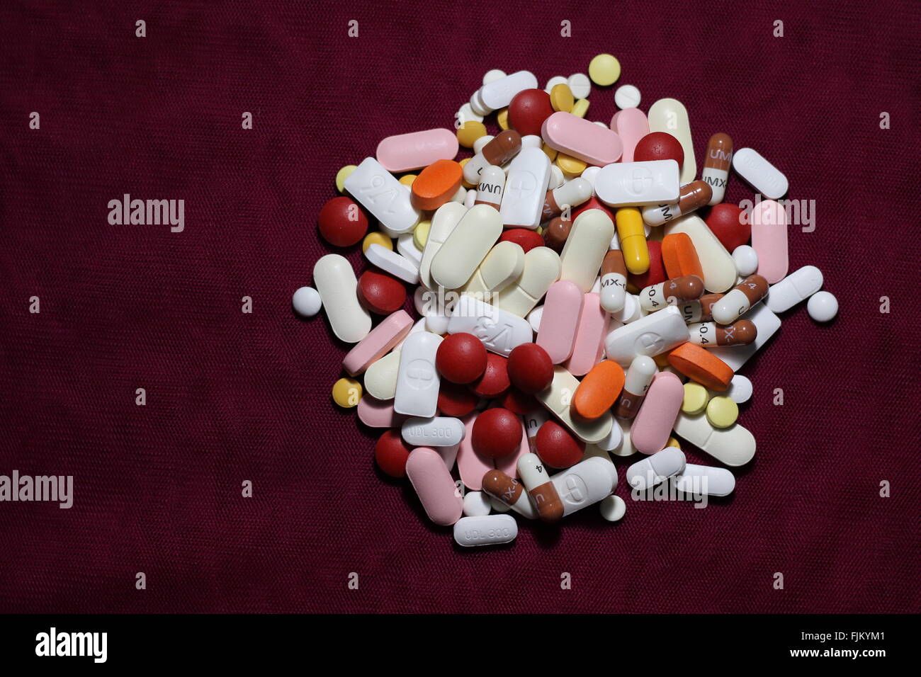 Medicine/Capsules and pills on red background Stock Photo - Alamy