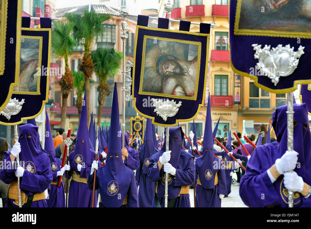 Processions of Nazarenos walk the streets at night during Semana Santa ...