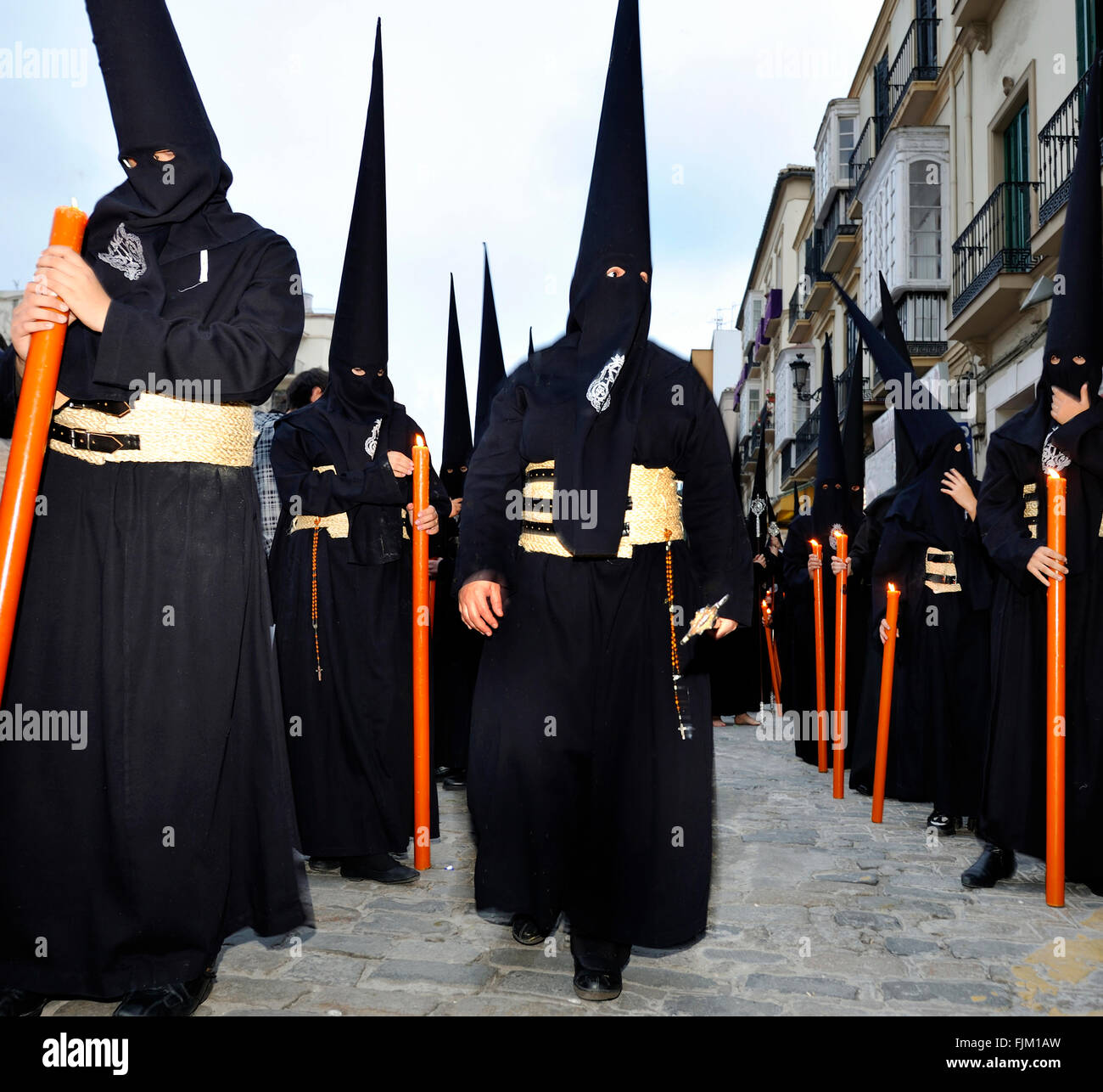 Processions of Nazarenos walk the streets at night during Semana Santa ...