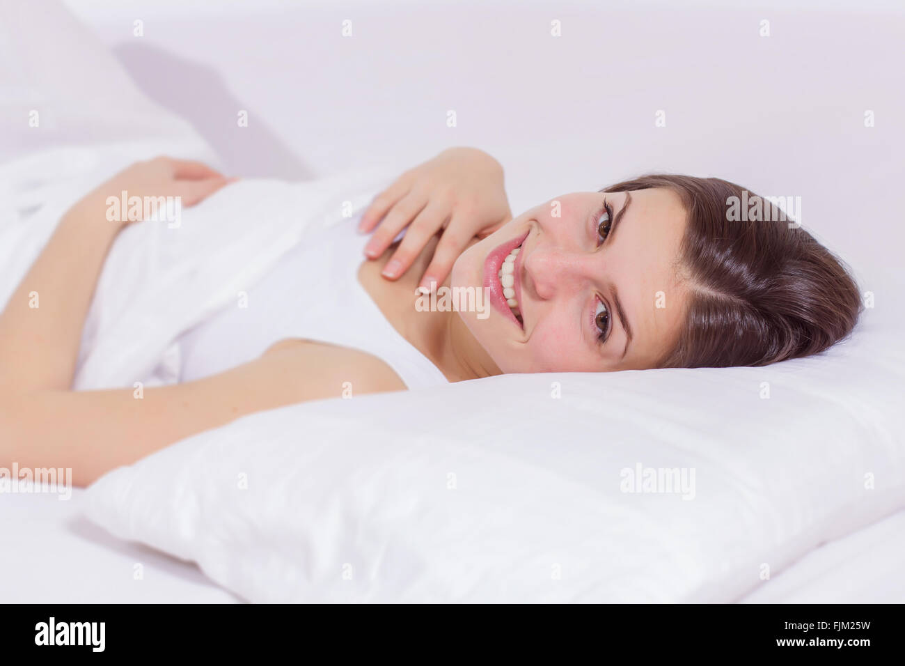 Happy young woman fully rested in the bed , wake up in the morning ...