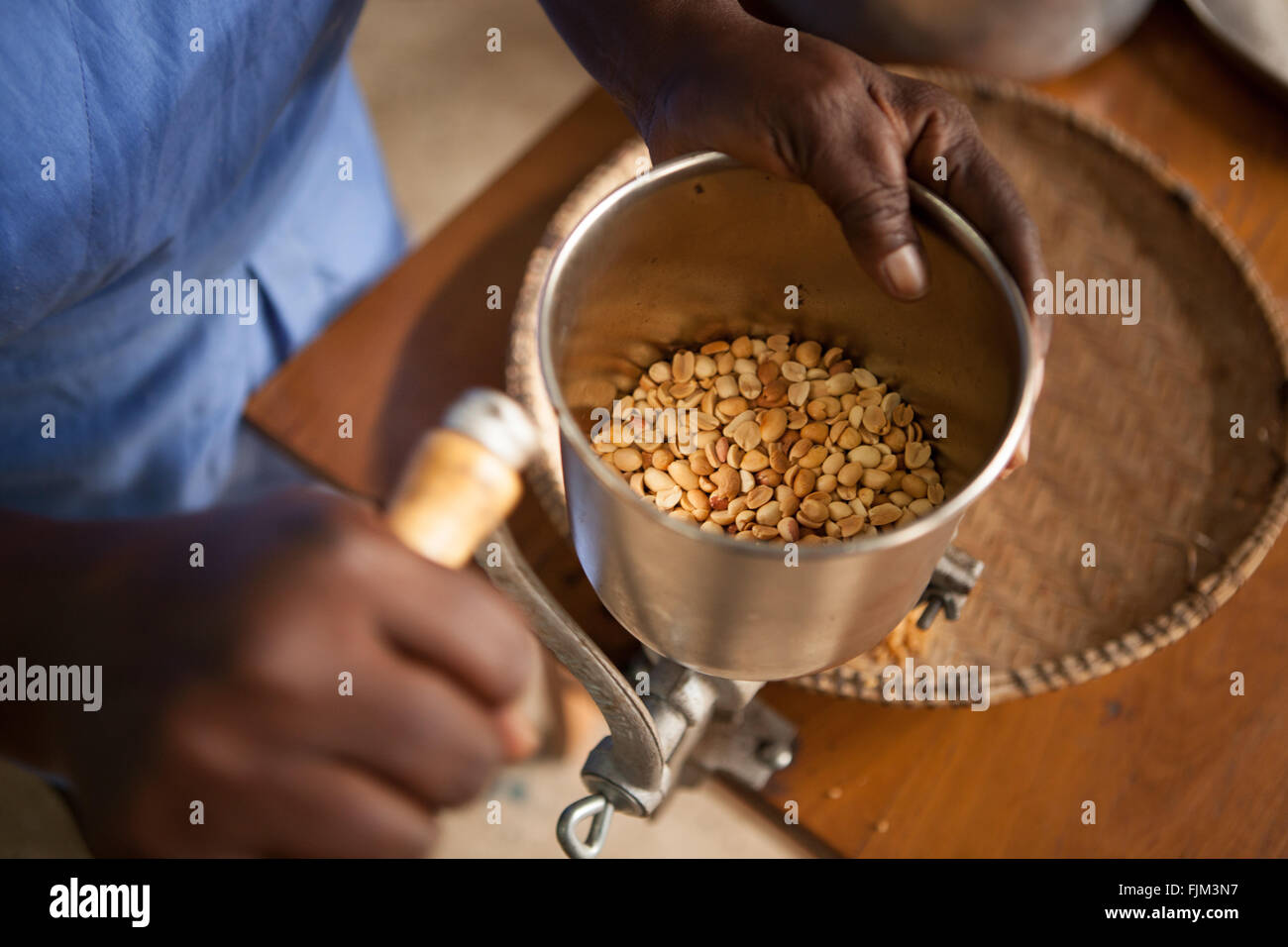 A woman grinding nuts, Africa Stock Photo - Alamy