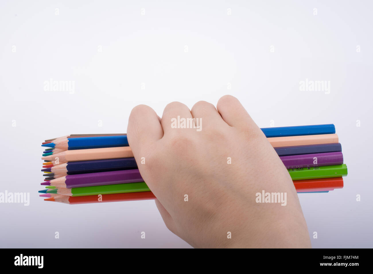 Hand holding color pencils on a white background Stock Photo - Alamy