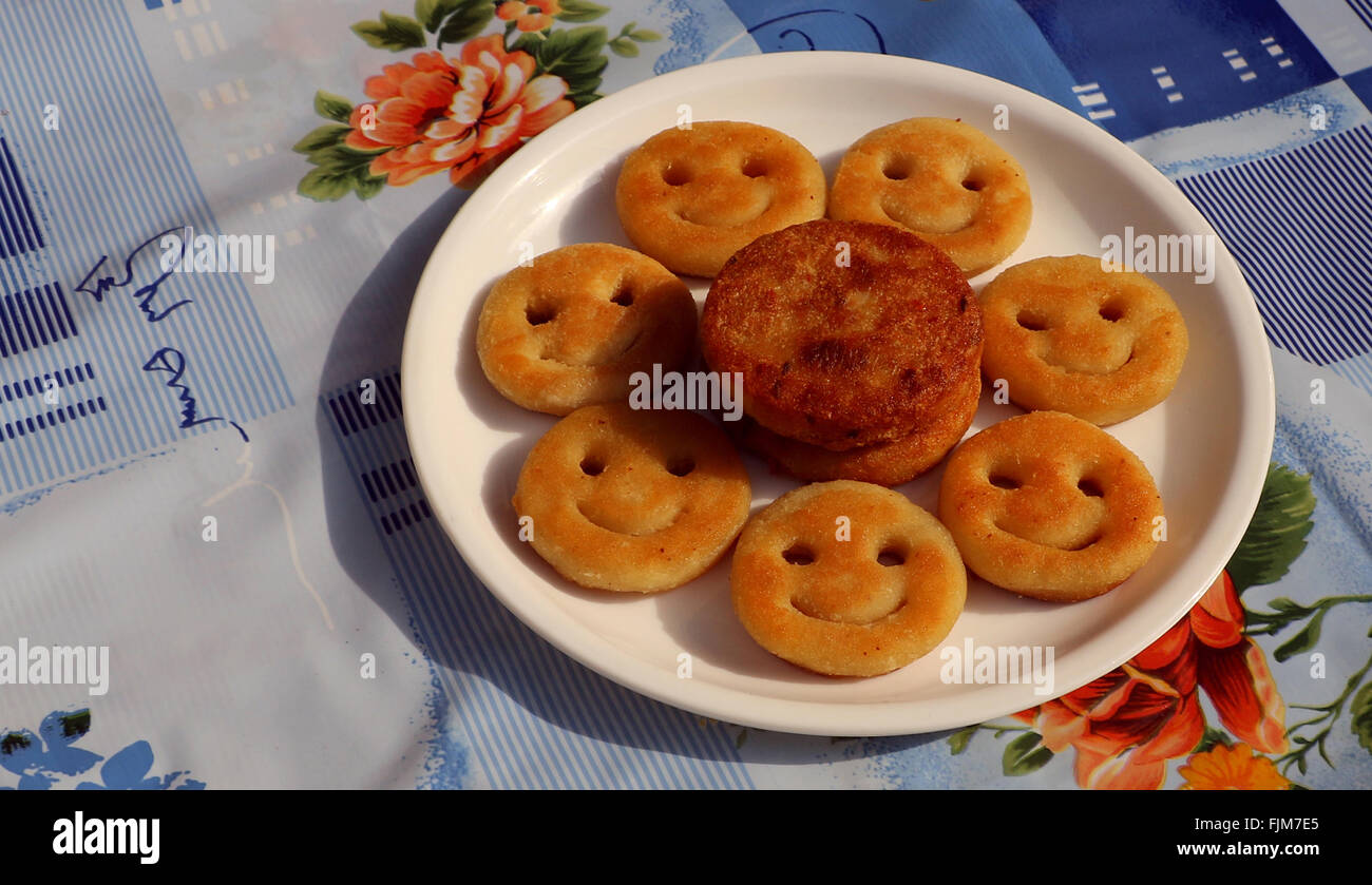Snack made with potato - fried potato as smile shape ; a popular Indian ...