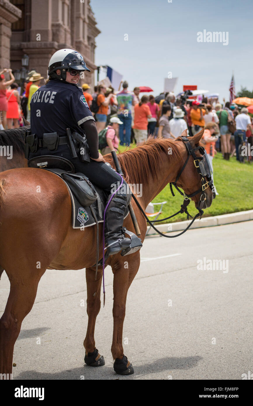 A mounted police officer stands by outside theTexas State capital in ...