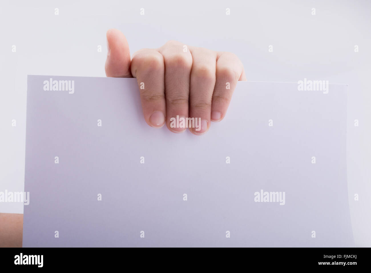 Hand holding a white sheet of paper on a white background Stock Photo ...