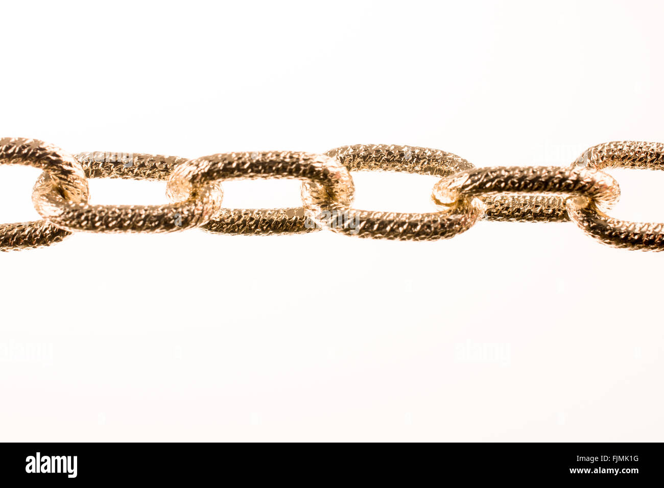 gold color metal chain on white background Stock Photo - Alamy