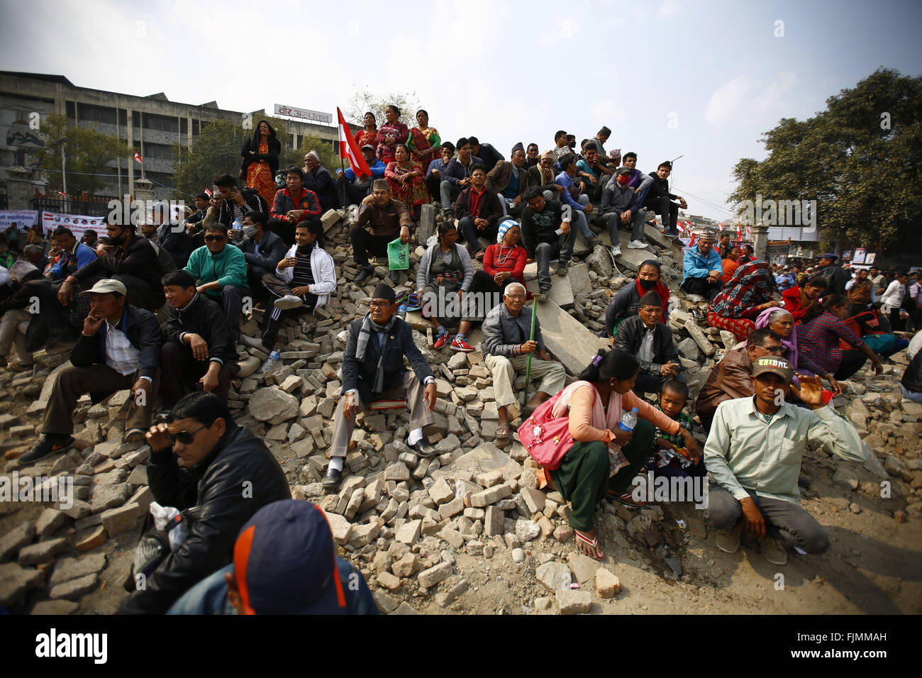 Kathmandu, Nepal. 3rd Mar, 2016. Nepalese people sit on top of bricks ...