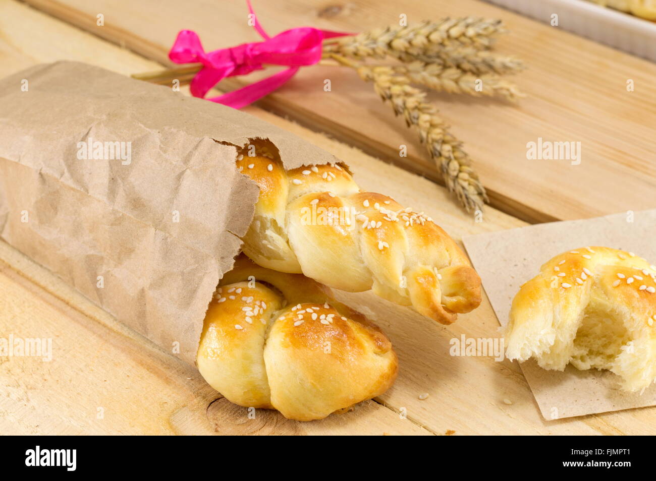 Homemade braid pastry in a paper with wheat plant Stock Photo - Alamy