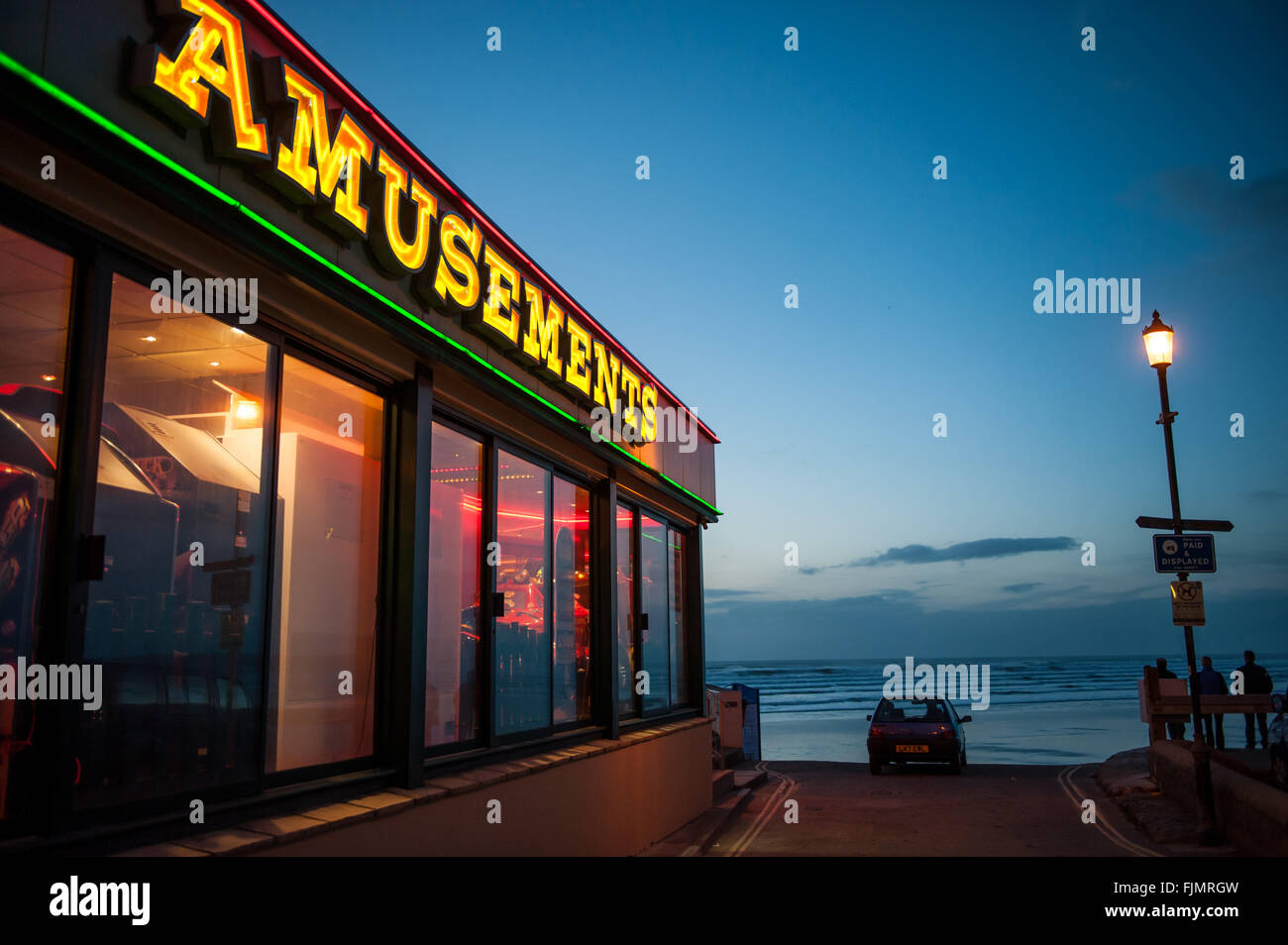 Amusement arcade at sunset at the seaside Stock Photo - Alamy