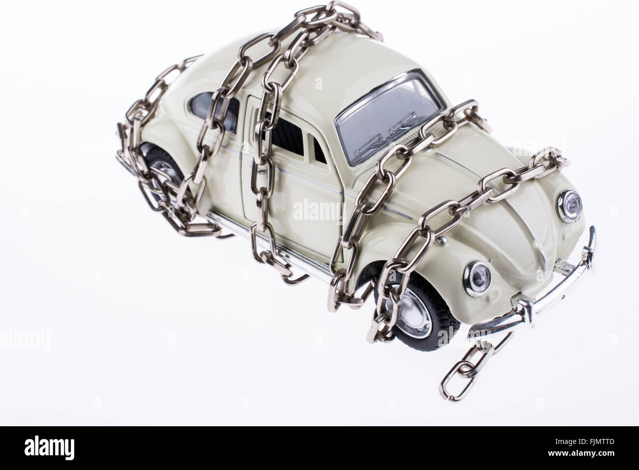 Chained white car on white background Stock Photo - Alamy