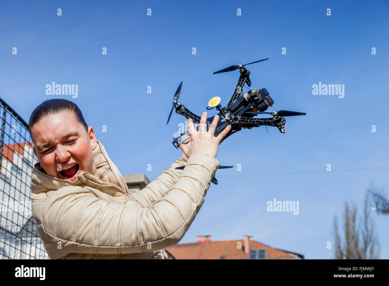 Pretty young woman screams just a moment before drone quadrocopter ...