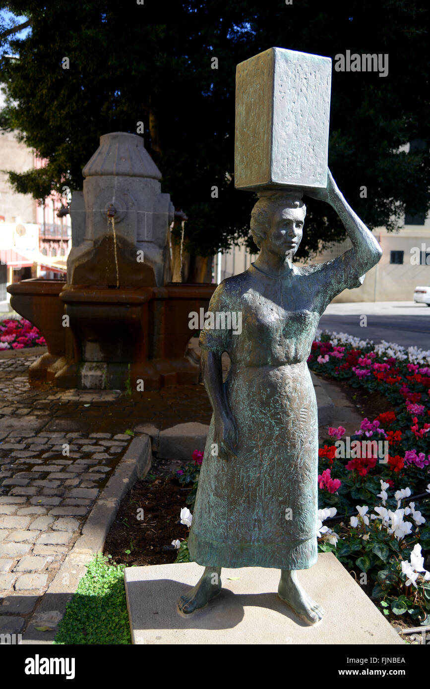 Statue of a woman carrying a pot on her head. La Aguadora de Santa Cruz ...