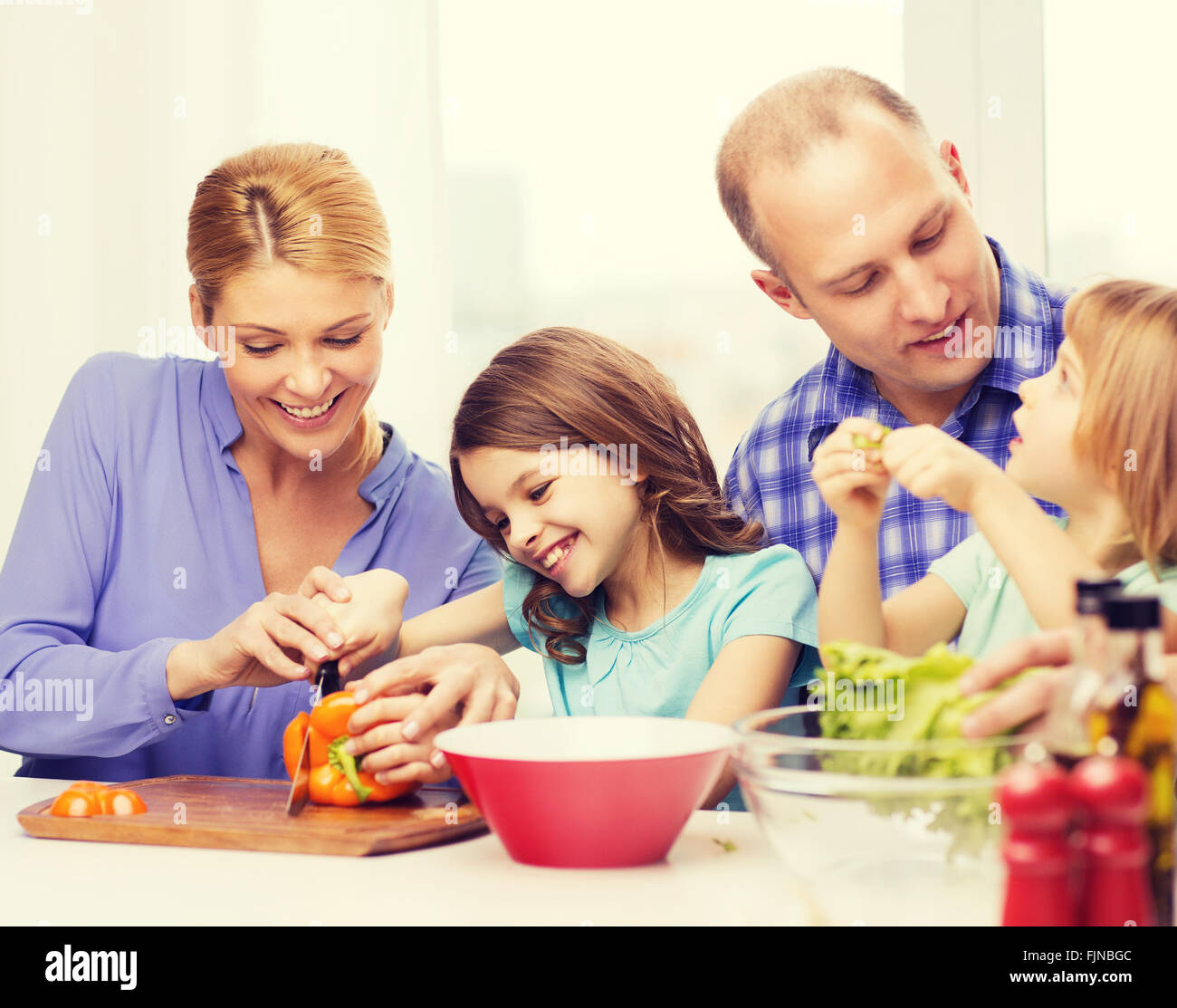 happy family with two kids making dinner at home Stock Photo - Alamy