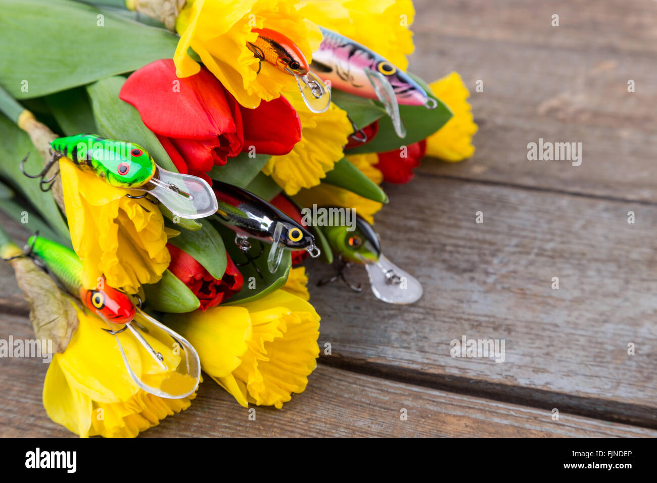 fishing tackles with bouquet of spring flowers narcissus and tulips on ...