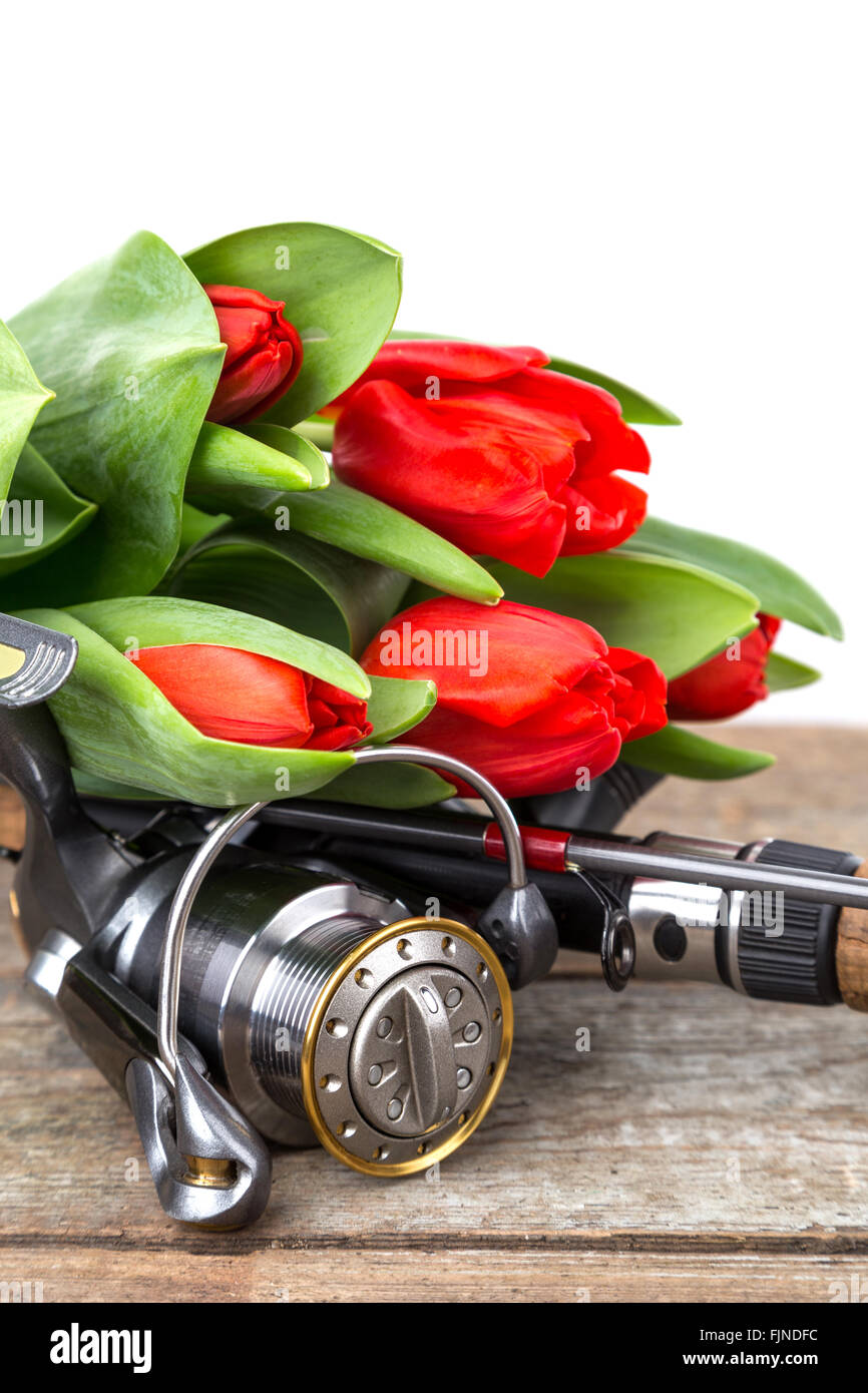 fishing tackles with bouquet of spring flowers tulips on wooden ...