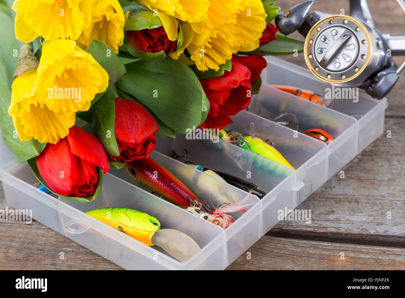 fishing tackles with bouquet of spring flowers narcissus and tulips on ...