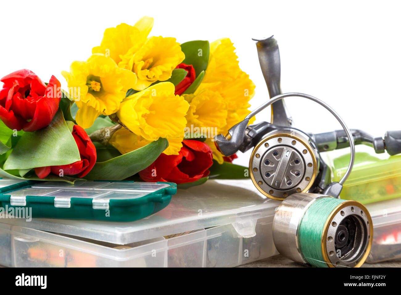 fishing tackles with bouquet of spring flowers narcissus and tulips on ...