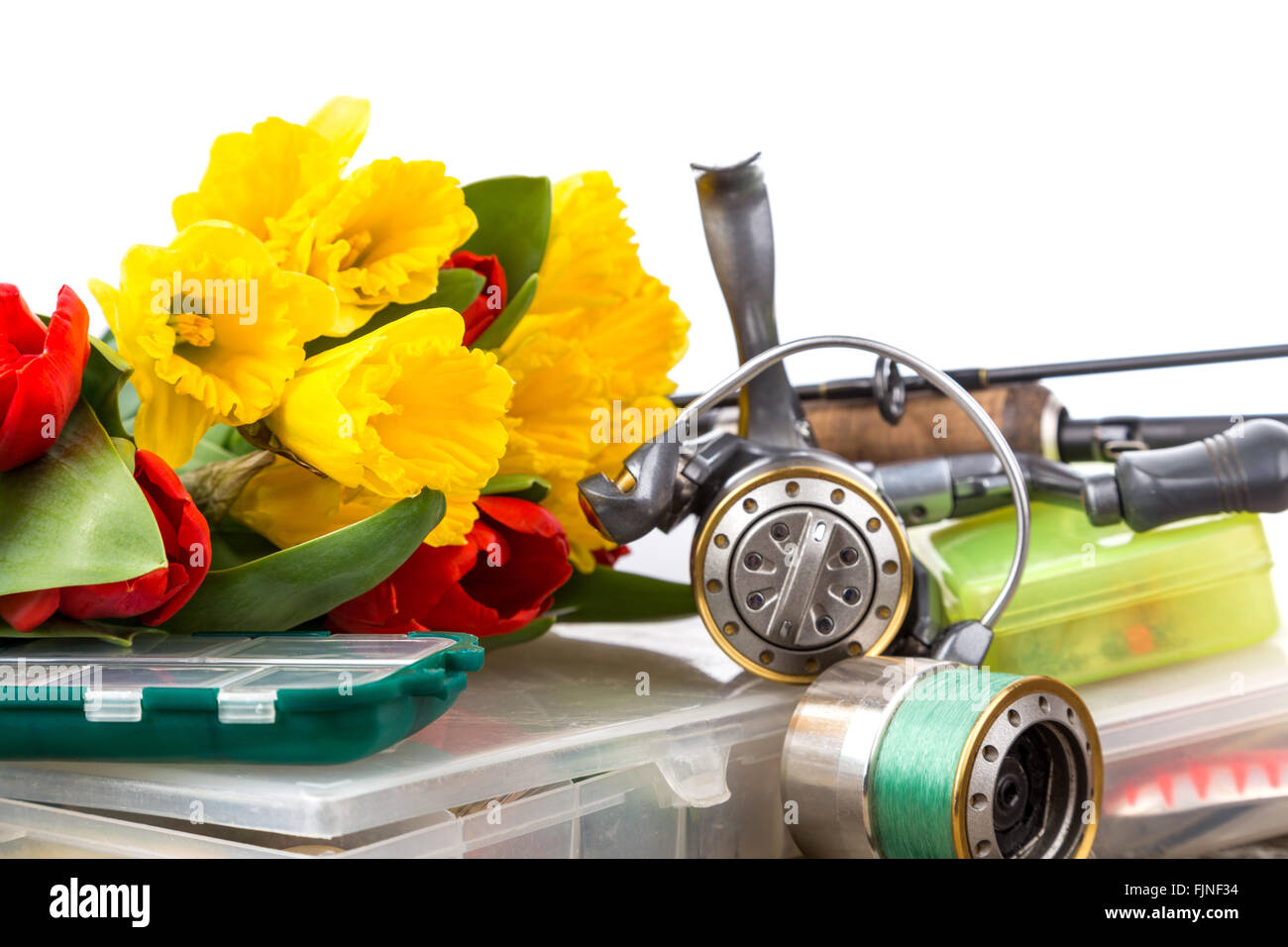 fishing tackles with bouquet of spring flowers narcissus and tulips on ...