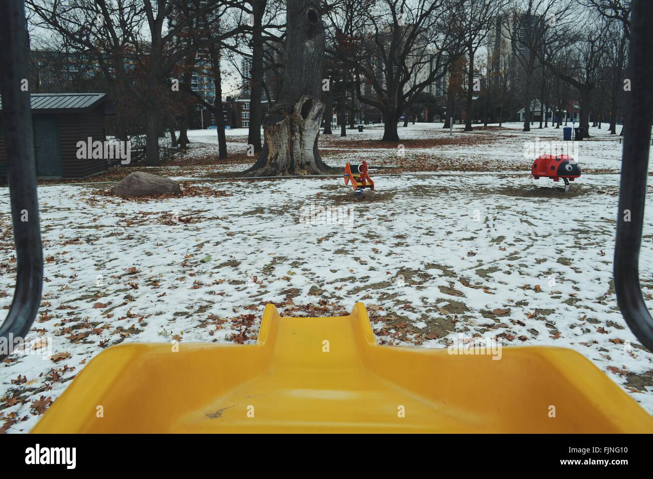 Yellow slide in playground winter childhood hi-res stock photography ...