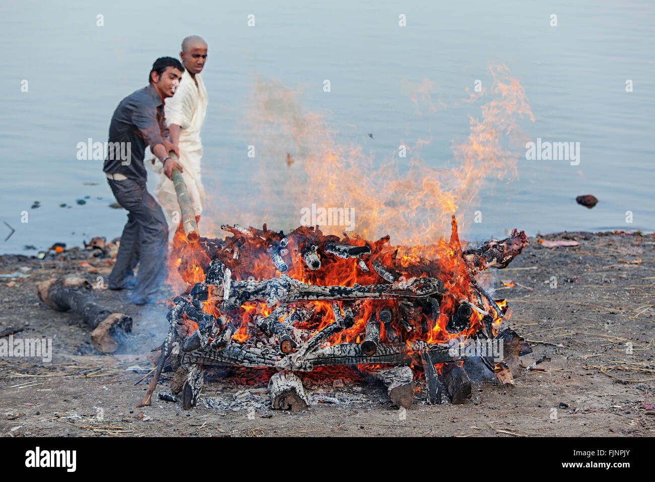 Cremation fire at the bank of holy Ganges river. Varanasi, India Stock ...