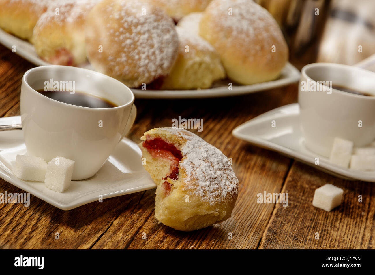 Traditional breaded cake with strawberry jam on wood table Stock Photo ...