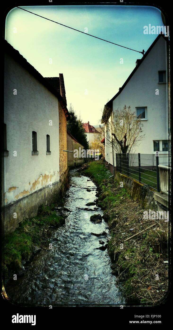 Stream Flowing Amidst Houses Stock Photo - Alamy