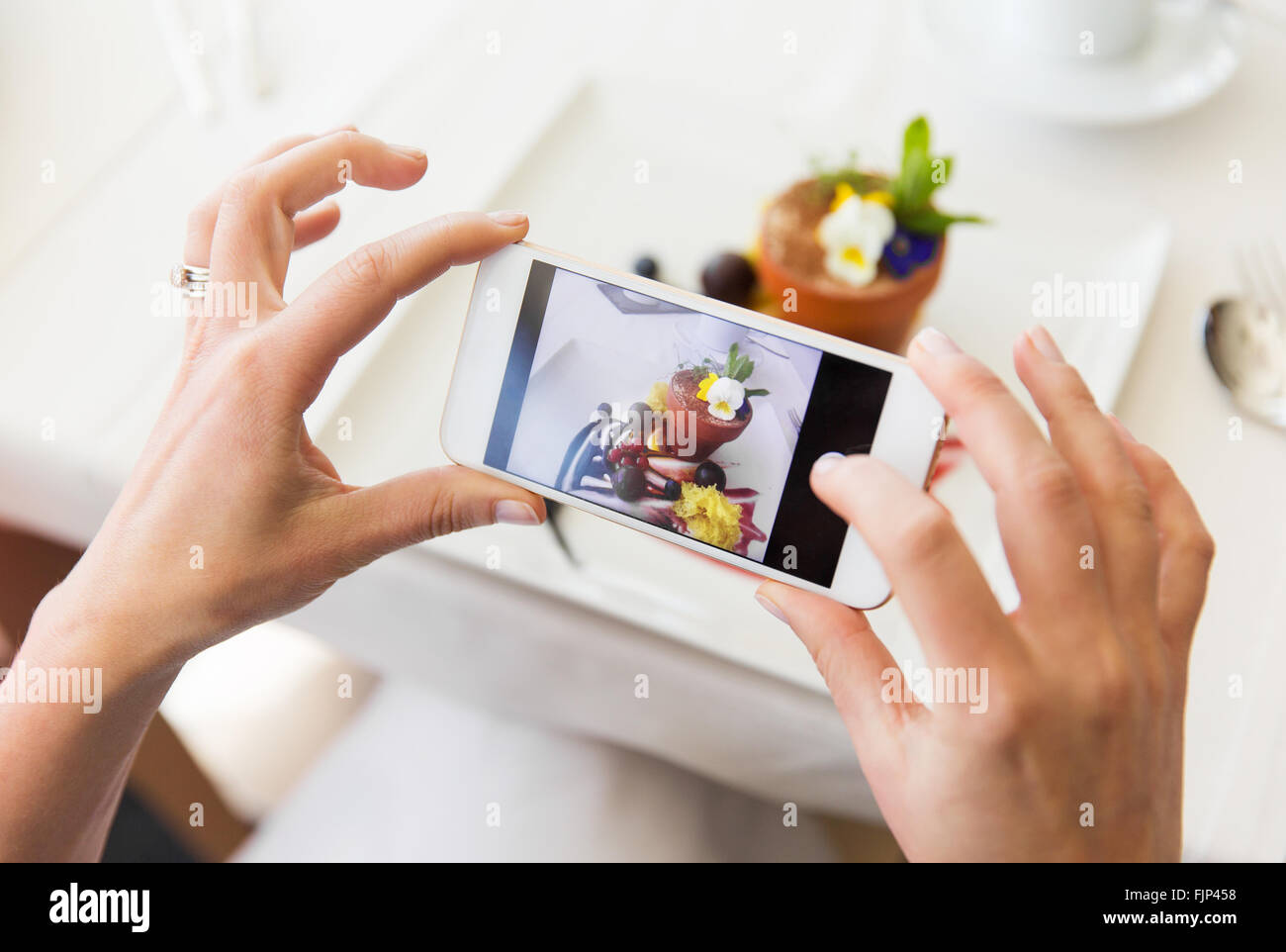 close up of woman picturing food by smartphone Stock Photo - Alamy