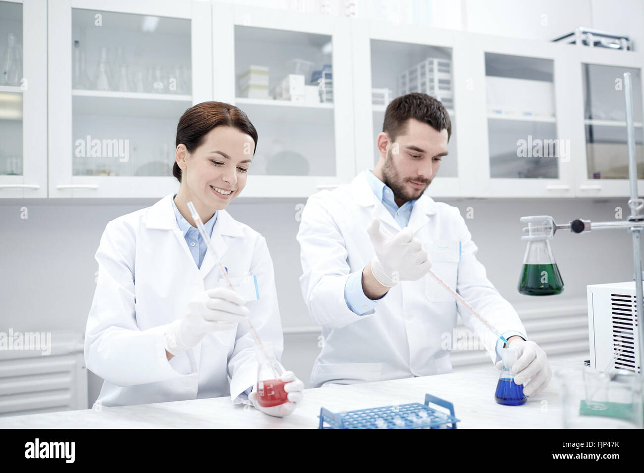 Young scientists researchers working hi-res stock photography and ...