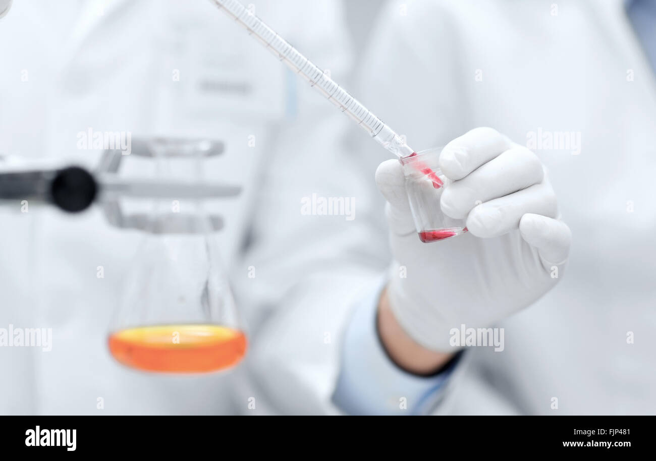 close up of scientists filling test tube in lab Stock Photo - Alamy