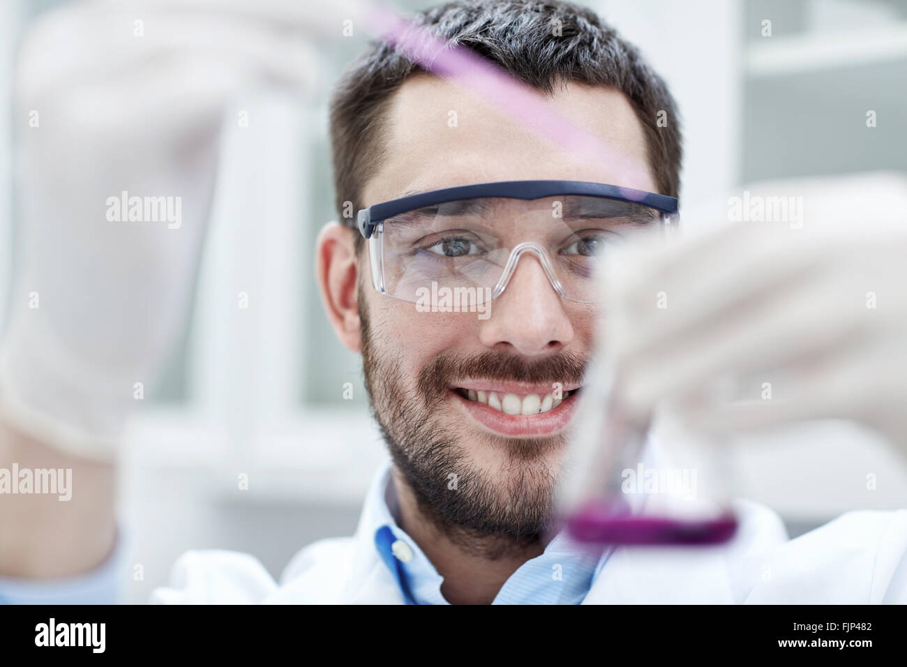 Smiling scientist looking test hi-res stock photography and images - Alamy