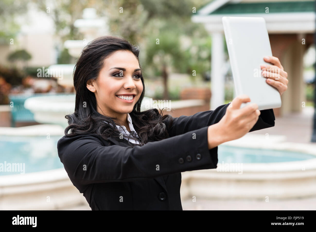 Young Hispanic businesswoman taking self-portrait selfie with digital ...