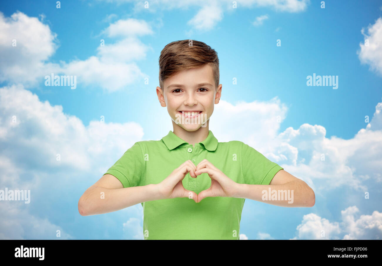 happy boy showing heart hand sign over blue sky Stock Photo - Alamy