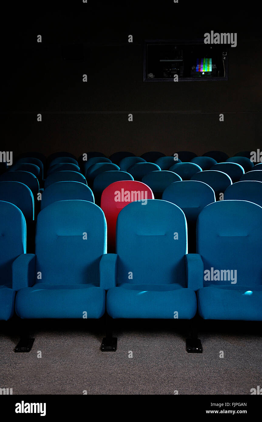 Cinema seats in a movie theater with one reserved seat Stock Photo - Alamy