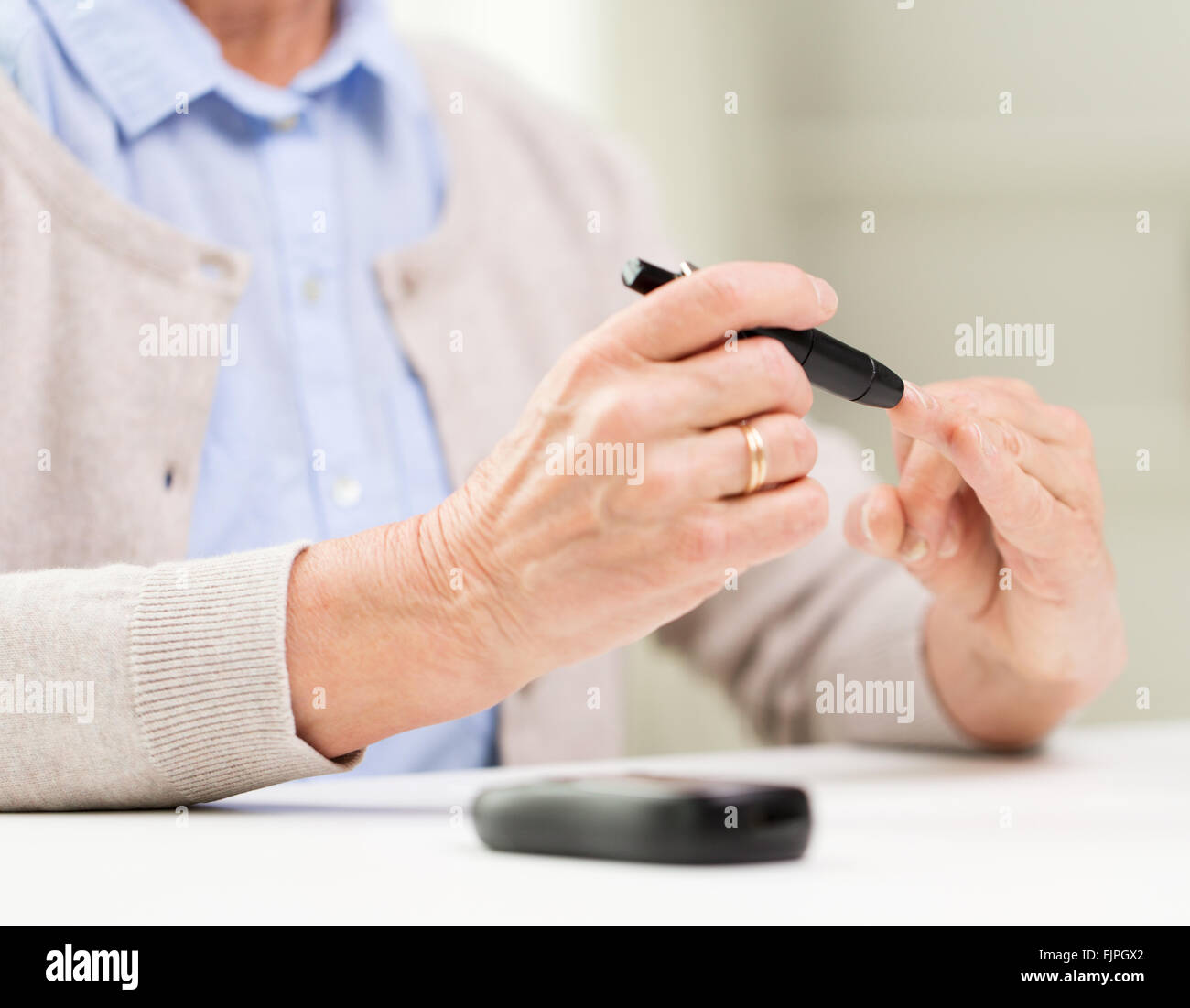 senior woman with glucometer checking blood sugar Stock Photo - Alamy
