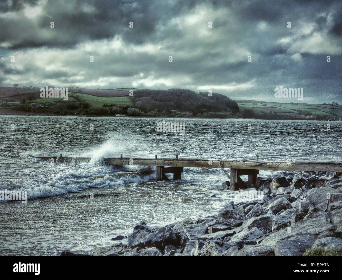 Jetty In Sea Below Cloudy Sky Stock Photo - Alamy
