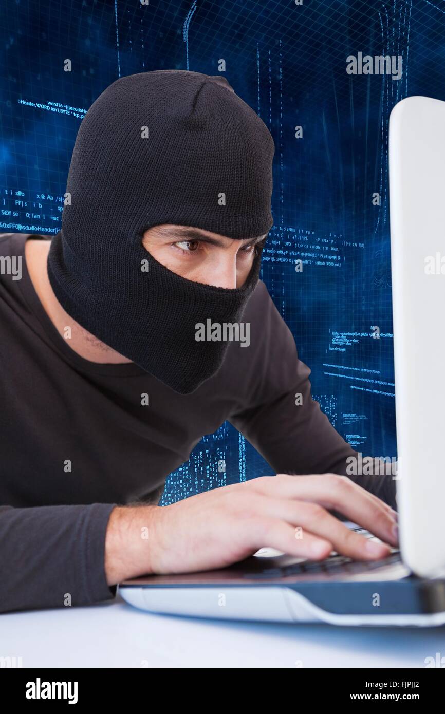 Masked man using laptop Stock Photo - Alamy