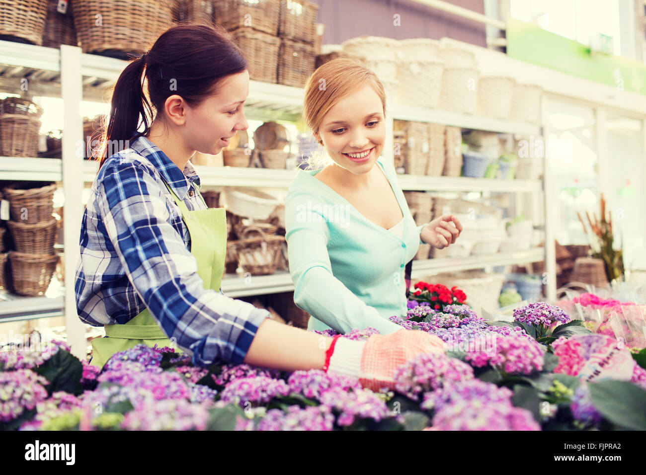 happy women choosing flowers in greenhouse Stock Photo - Alamy