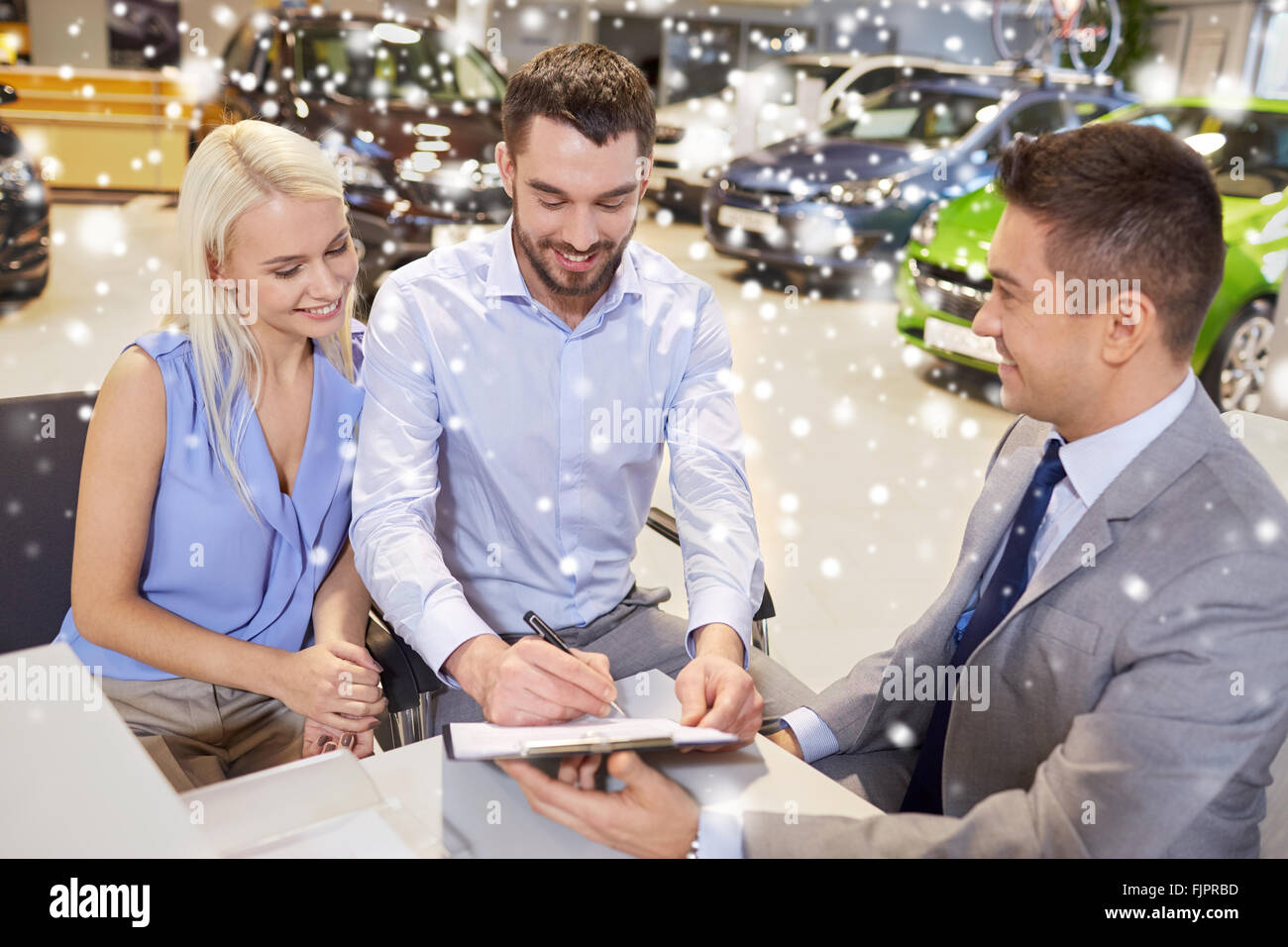 happy couple with car dealer in auto show or salon Stock Photo - Alamy