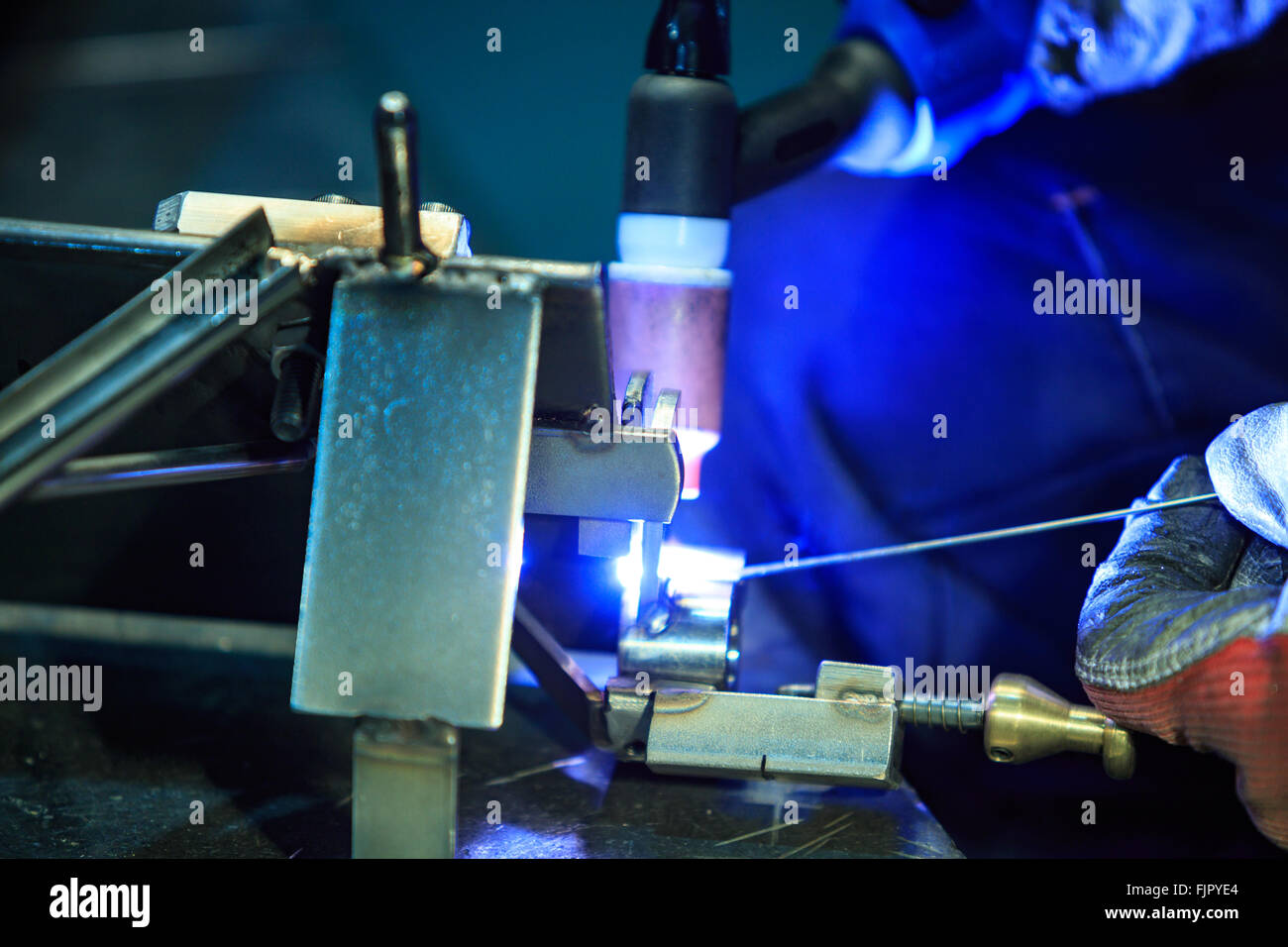 man welding iron factory Stock Photo - Alamy