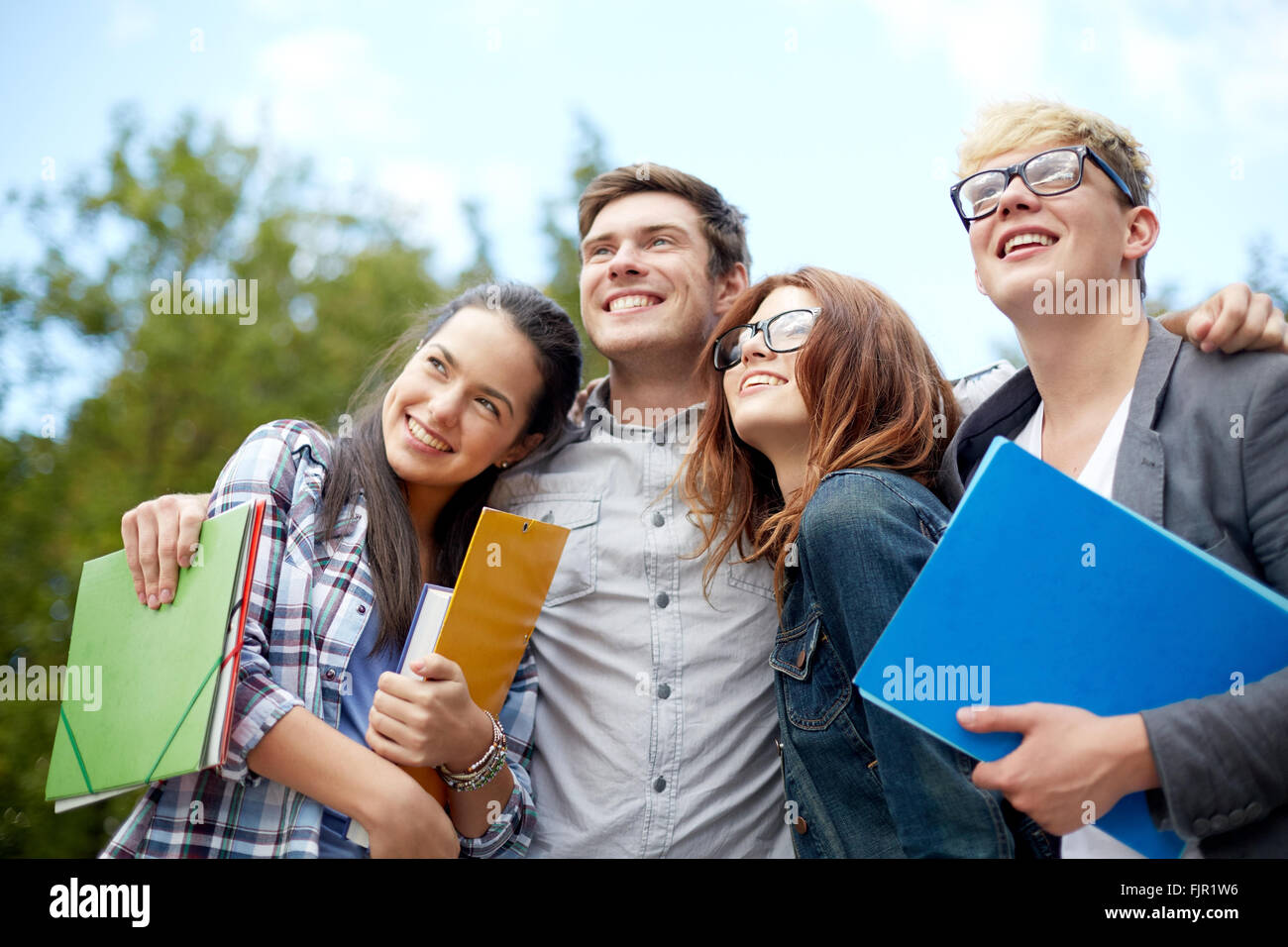 group of happy students with folders outdoors Stock Photo - Alamy
