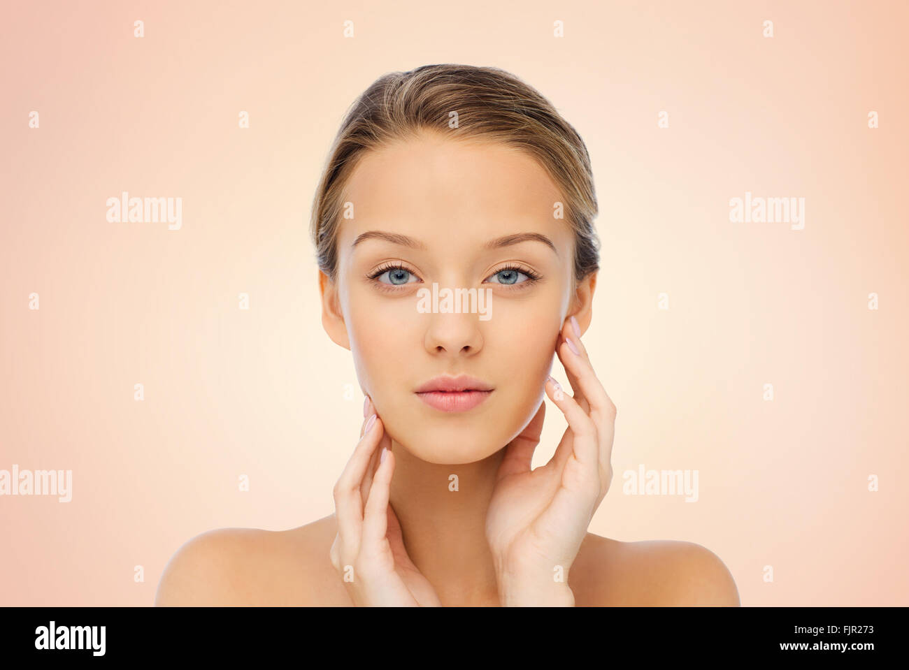 young woman touching her face Stock Photo - Alamy