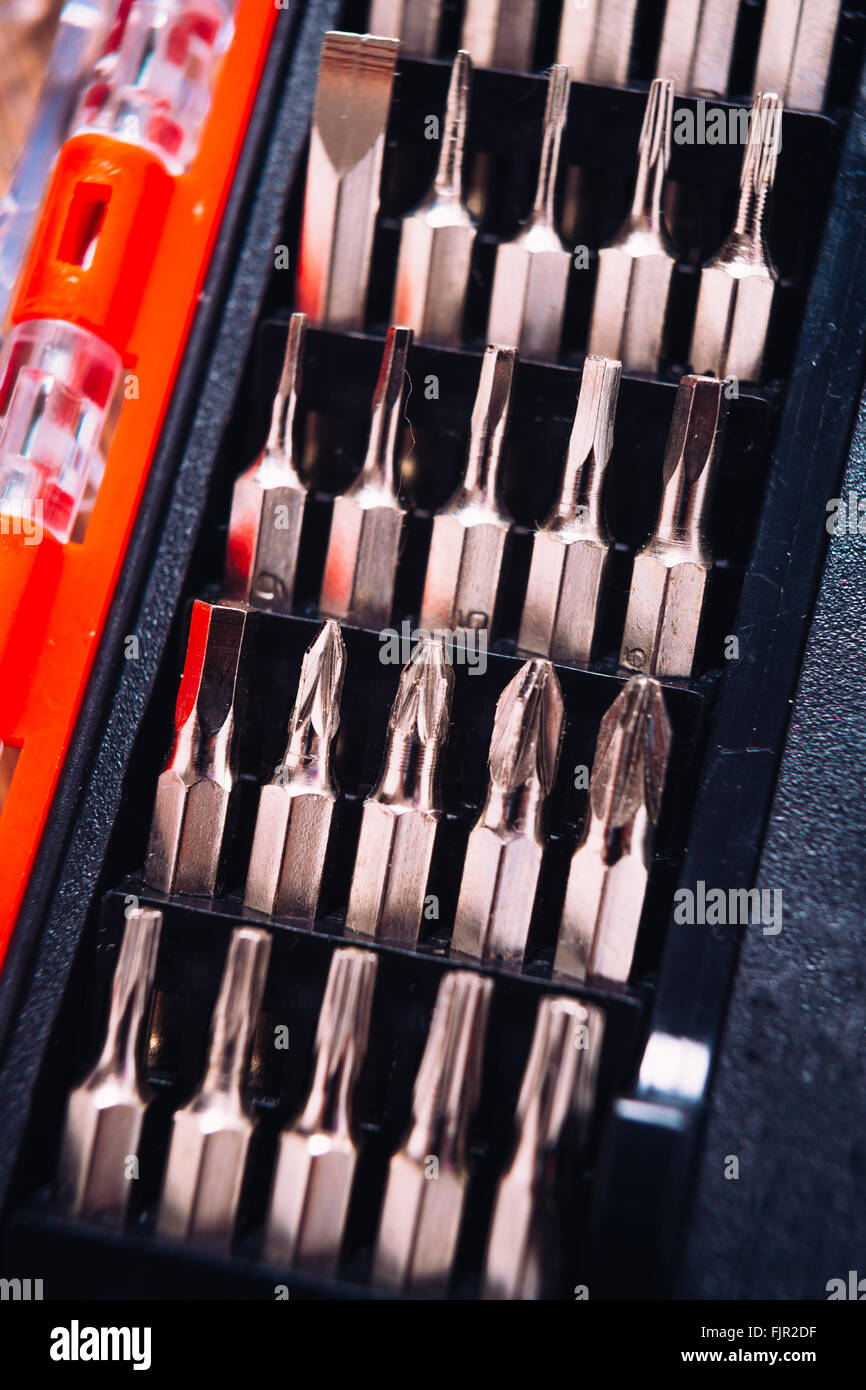 set of nozzles for screwdriver in red box on wooden background Stock ...